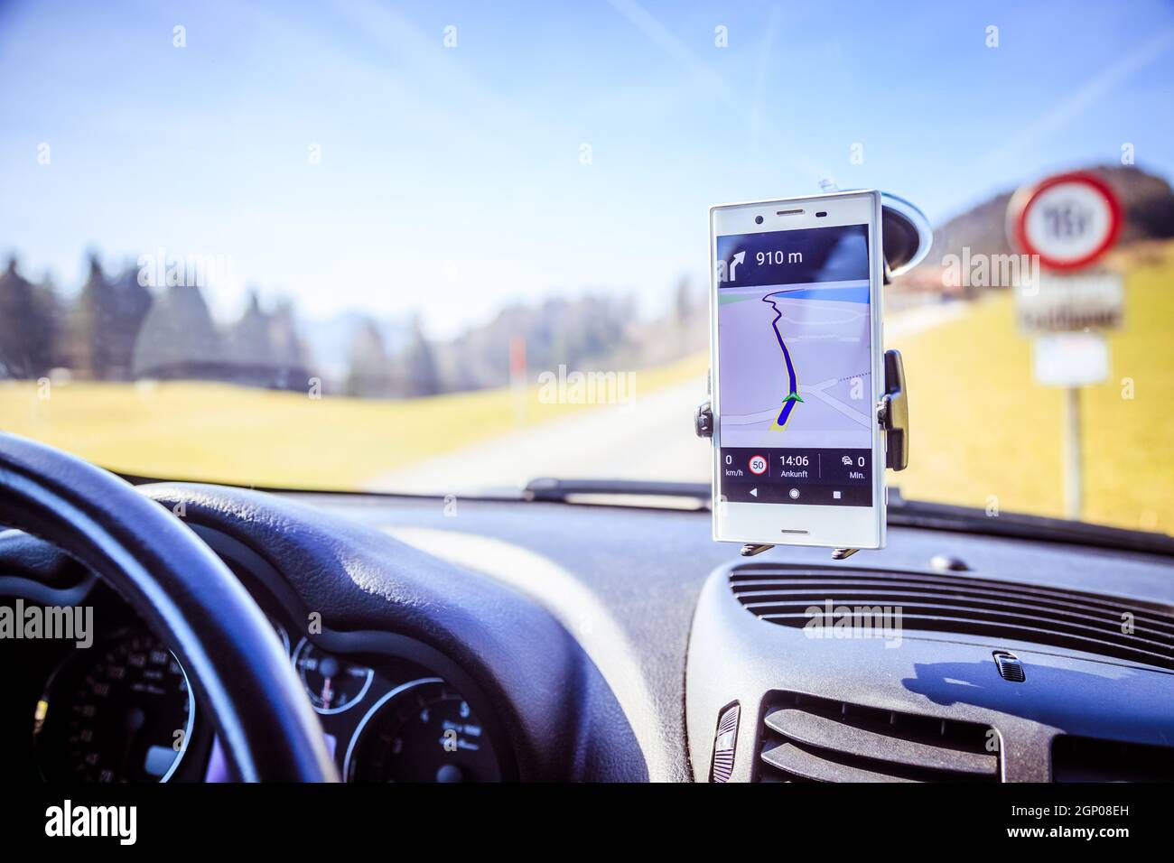 Interior of a modern car on a sunny day. Smartphone on mobile mount ...