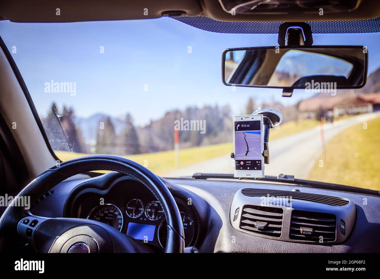Interior of a modern car on a sunny day. Smartphone on mobile mount ...