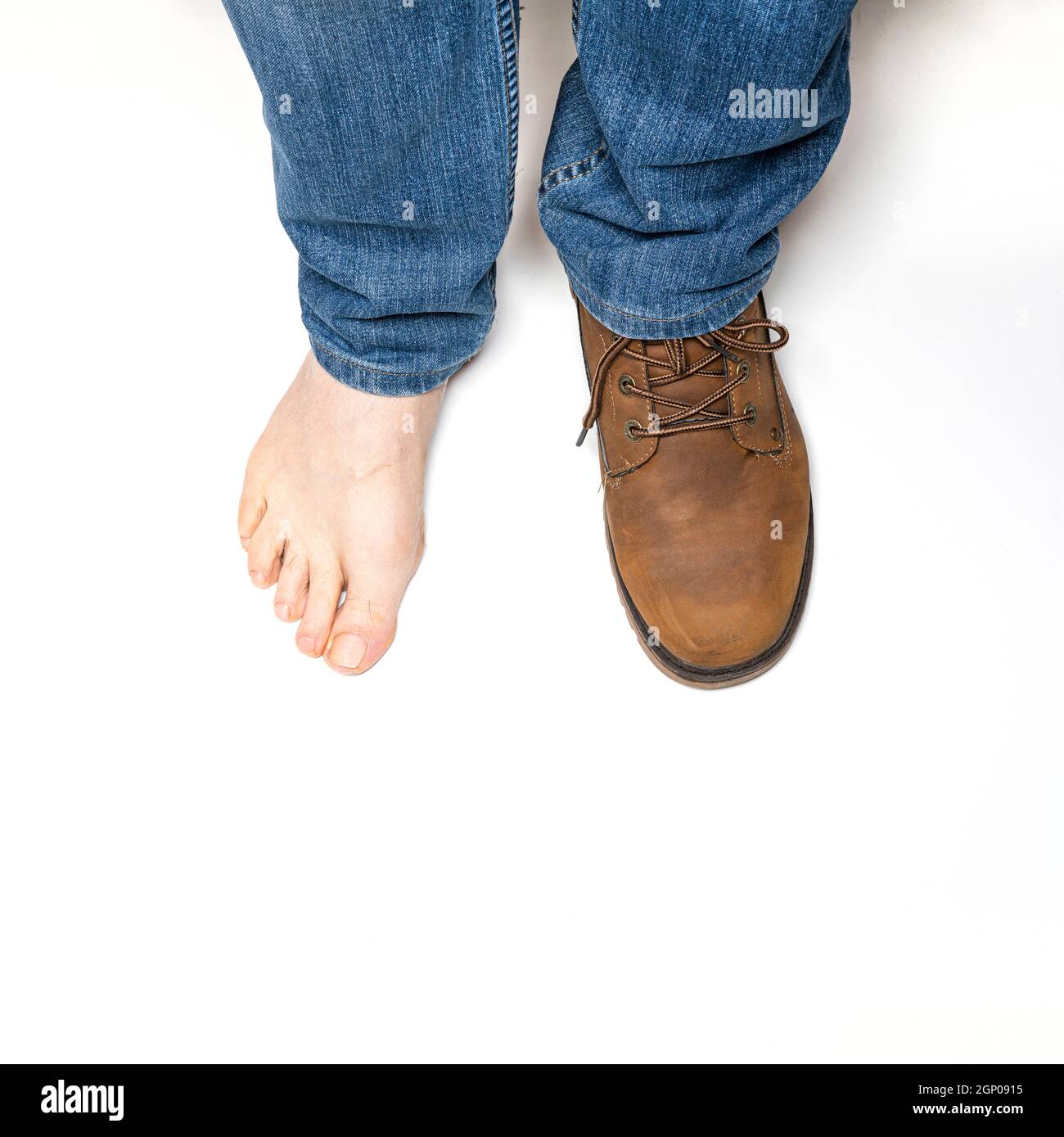 one foot with shoe and one barefoot Stock Photo - Alamy