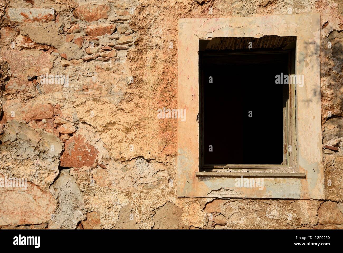 Old abandoned rural house facade with a claystone wall and an aged ...