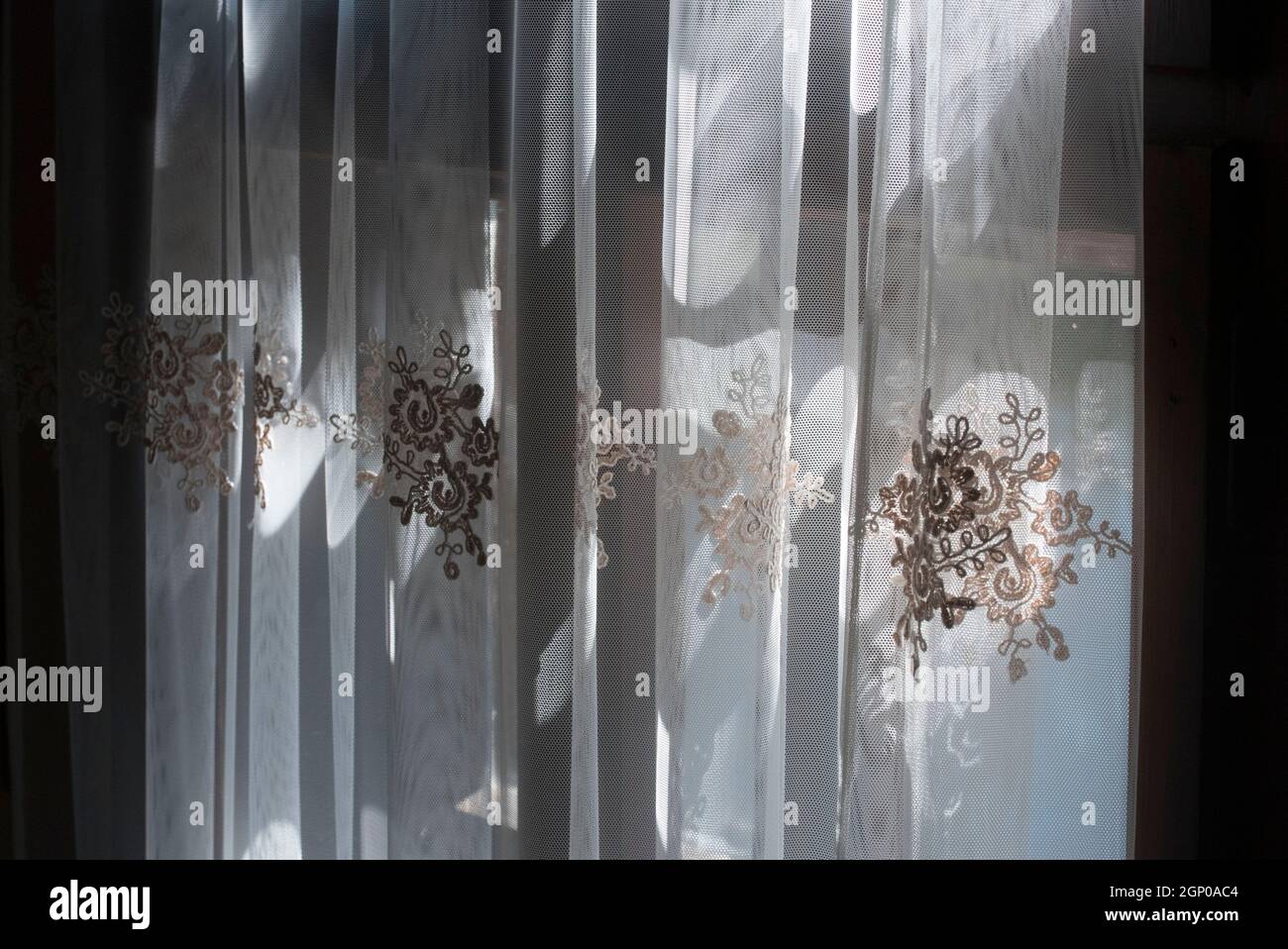 a curtain as visual protection in front of a window Stock Photo - Alamy