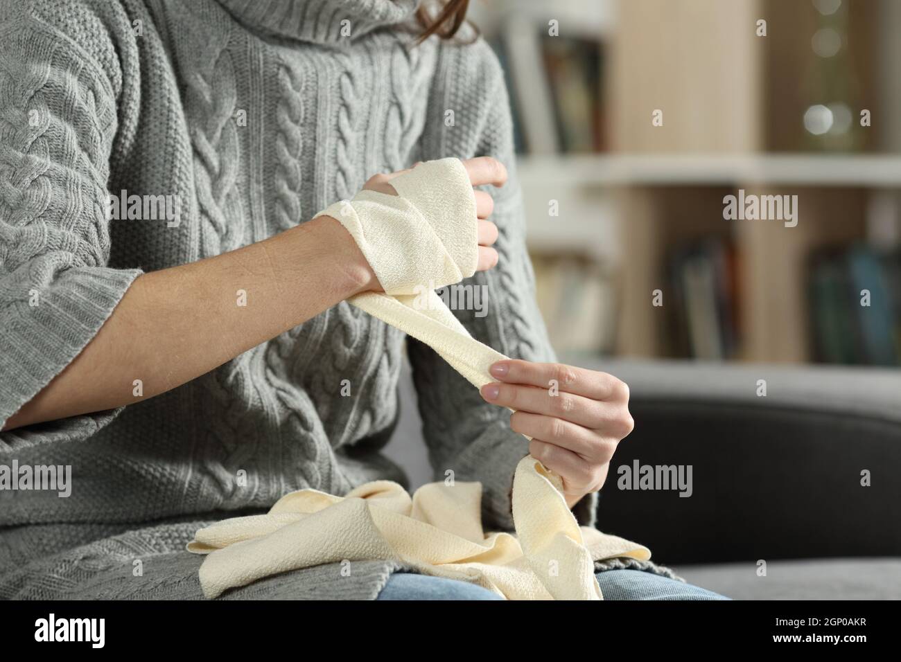 Close up of injured woman hands removing bandage from arm at home Stock ...