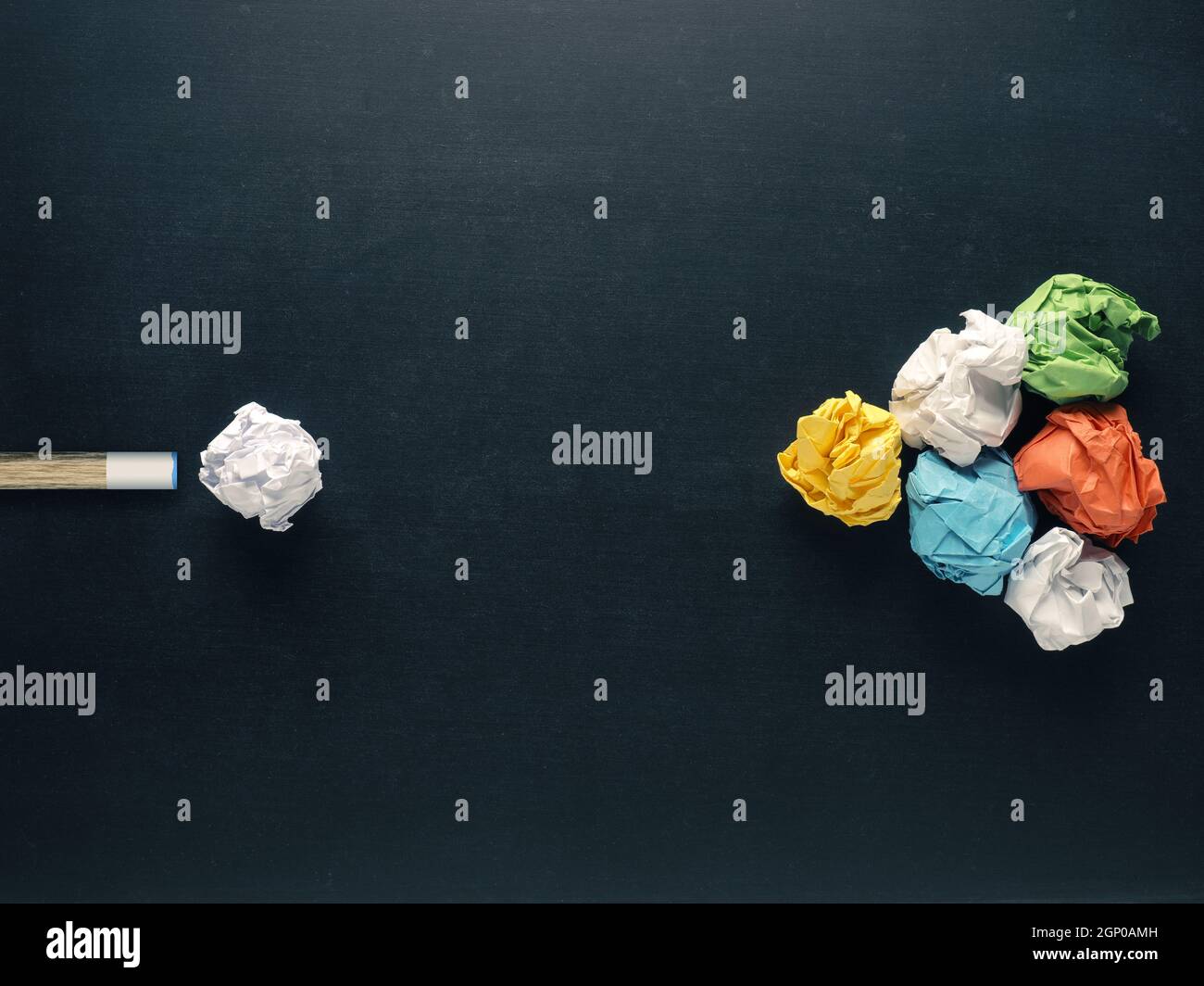 Cue aims at paper balls on a blackboard background, concept image for ...