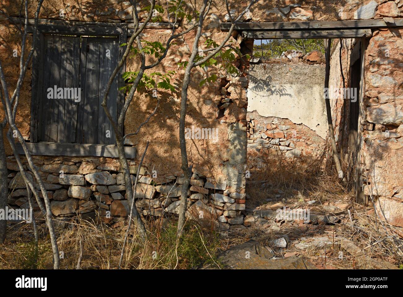 Old abandoned rural house facade with an aged mortared claystone wall ...