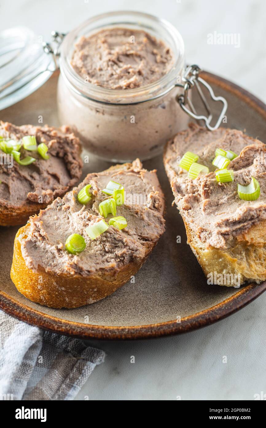 Liver pate on sliced baguette on plate Stock Photo - Alamy
