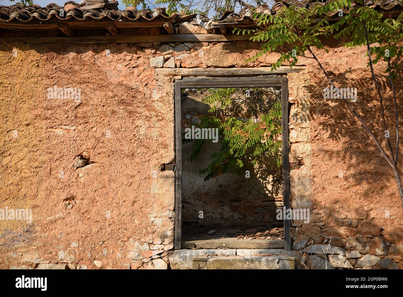 Old abandoned rural house weathered facade with aged claystone walls, a ...