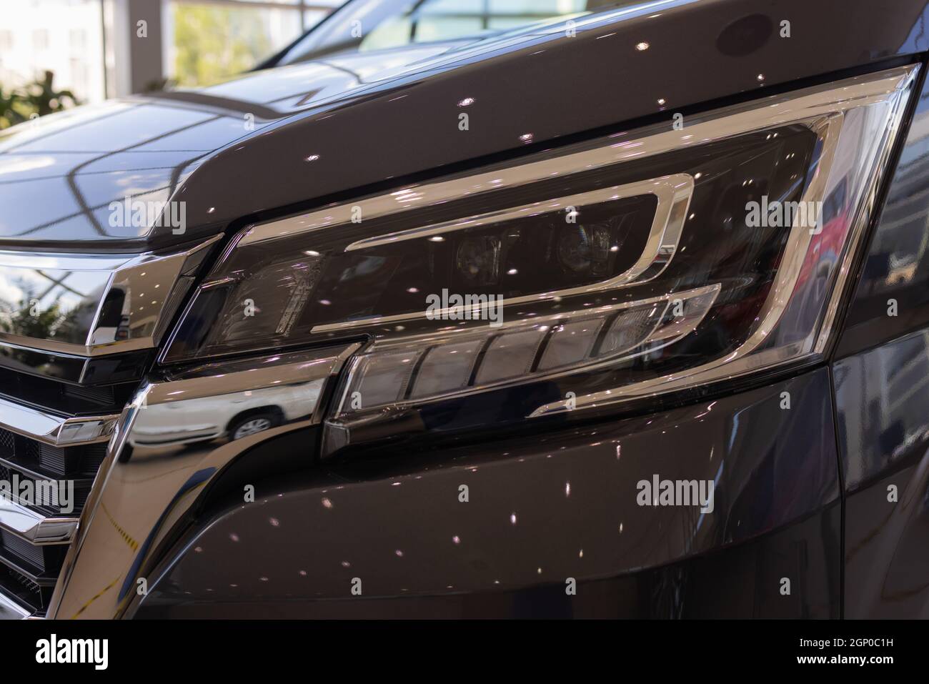 Front headlight of a passenger minibus close-up Stock Photo - Alamy