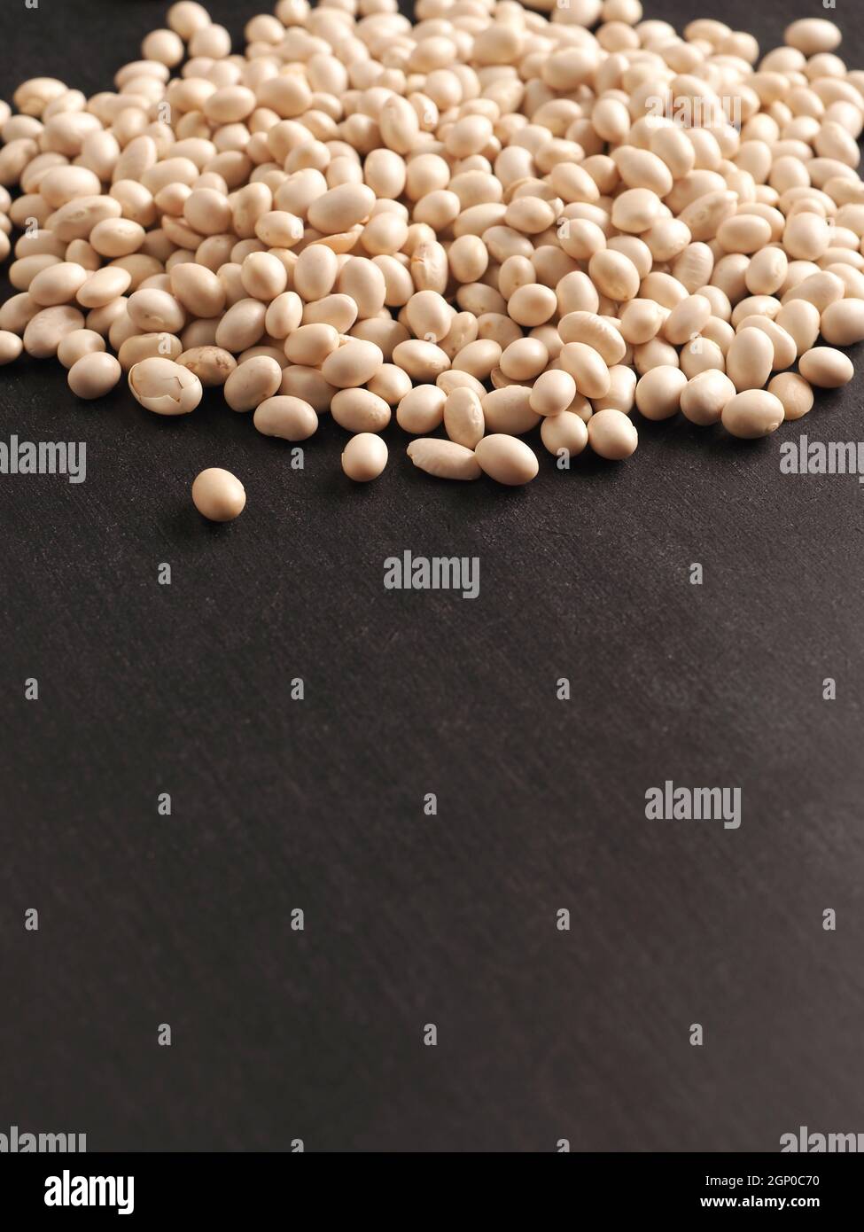 A heap of organic white beans on a blackboard with space for your text ...