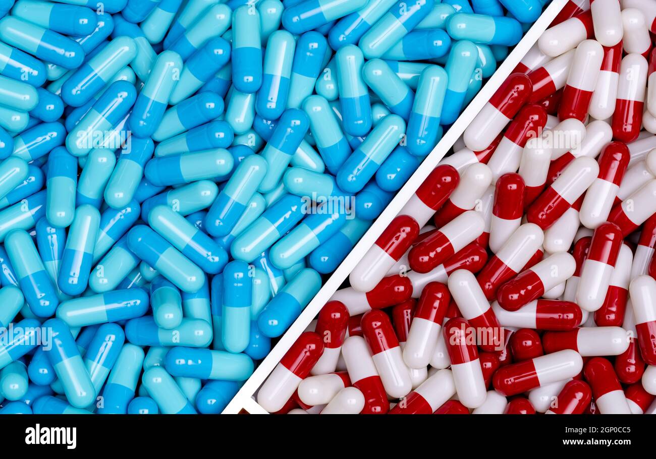 Top view of blue capsules and red-white capsules pills in a plastic ...