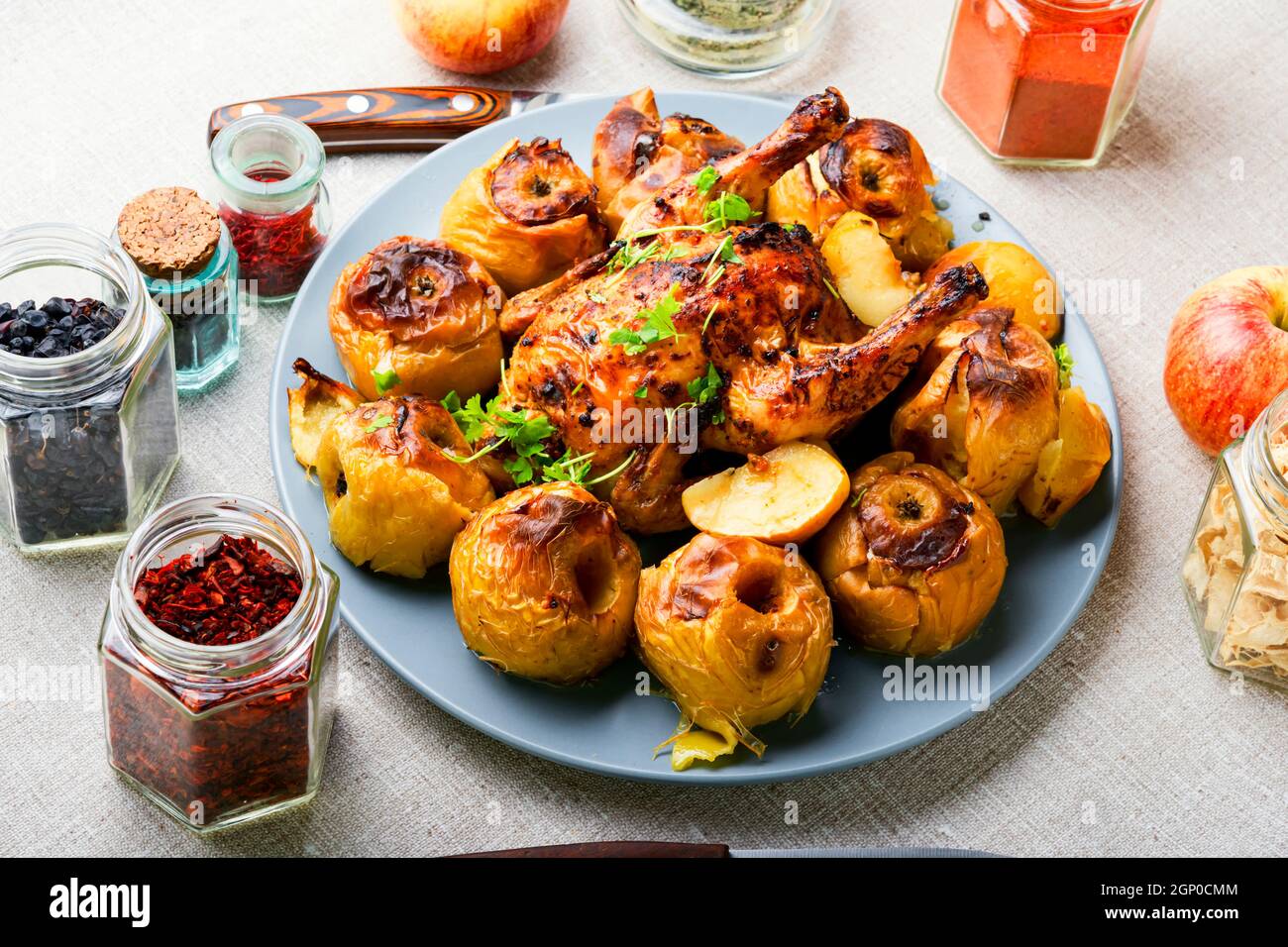 Homemade whole chicken or partridge baked with apples on a plate.Baked ...