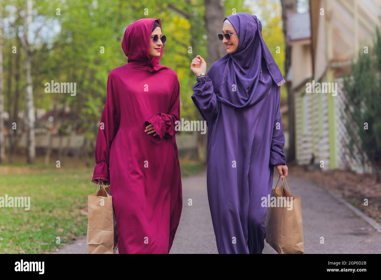 Islamic beautiful woman in a Muslim dress standing on a summer park ...