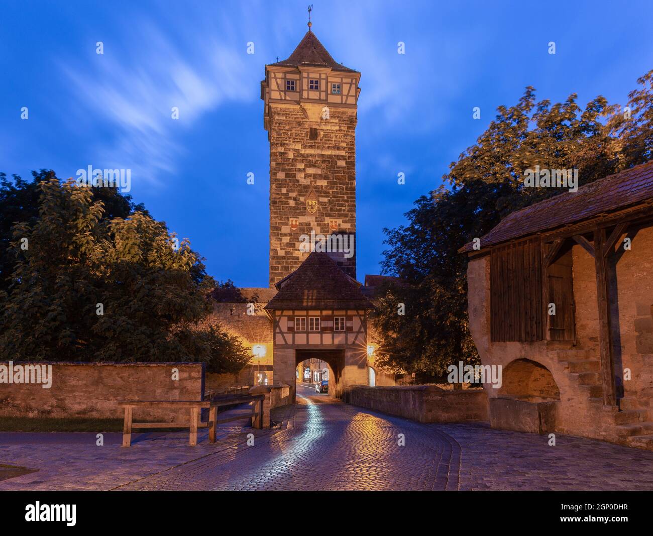 Old traditional medieval street in night illumination. Rothenburg ob ...