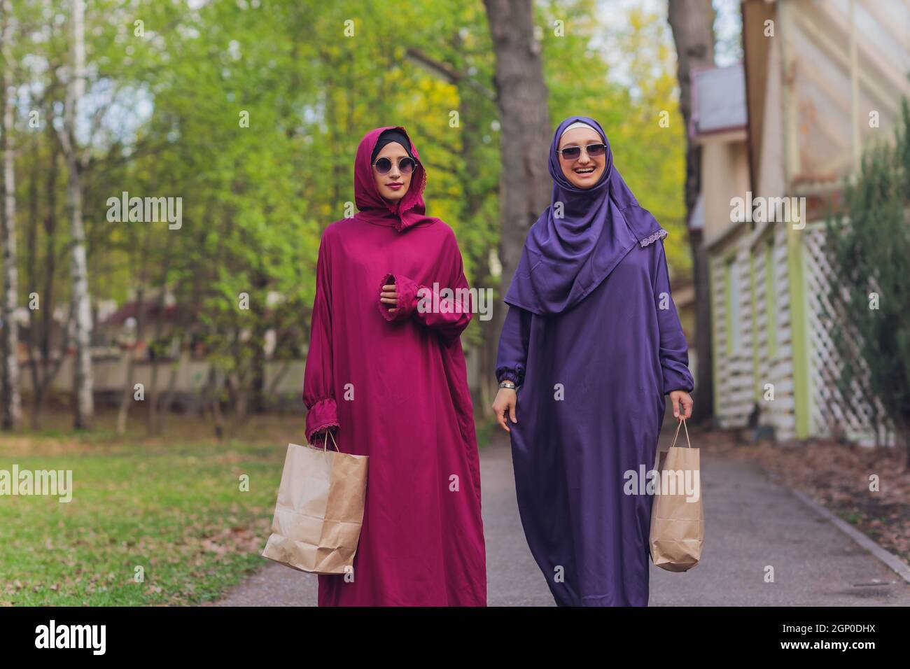 Islamic beautiful woman in a Muslim dress standing on a summer park ...