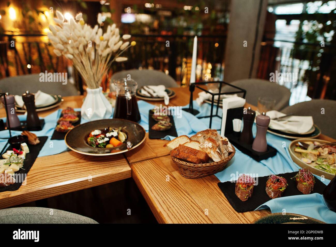 Beautifully laid tables with food, glasses and appliances in restaurant ...