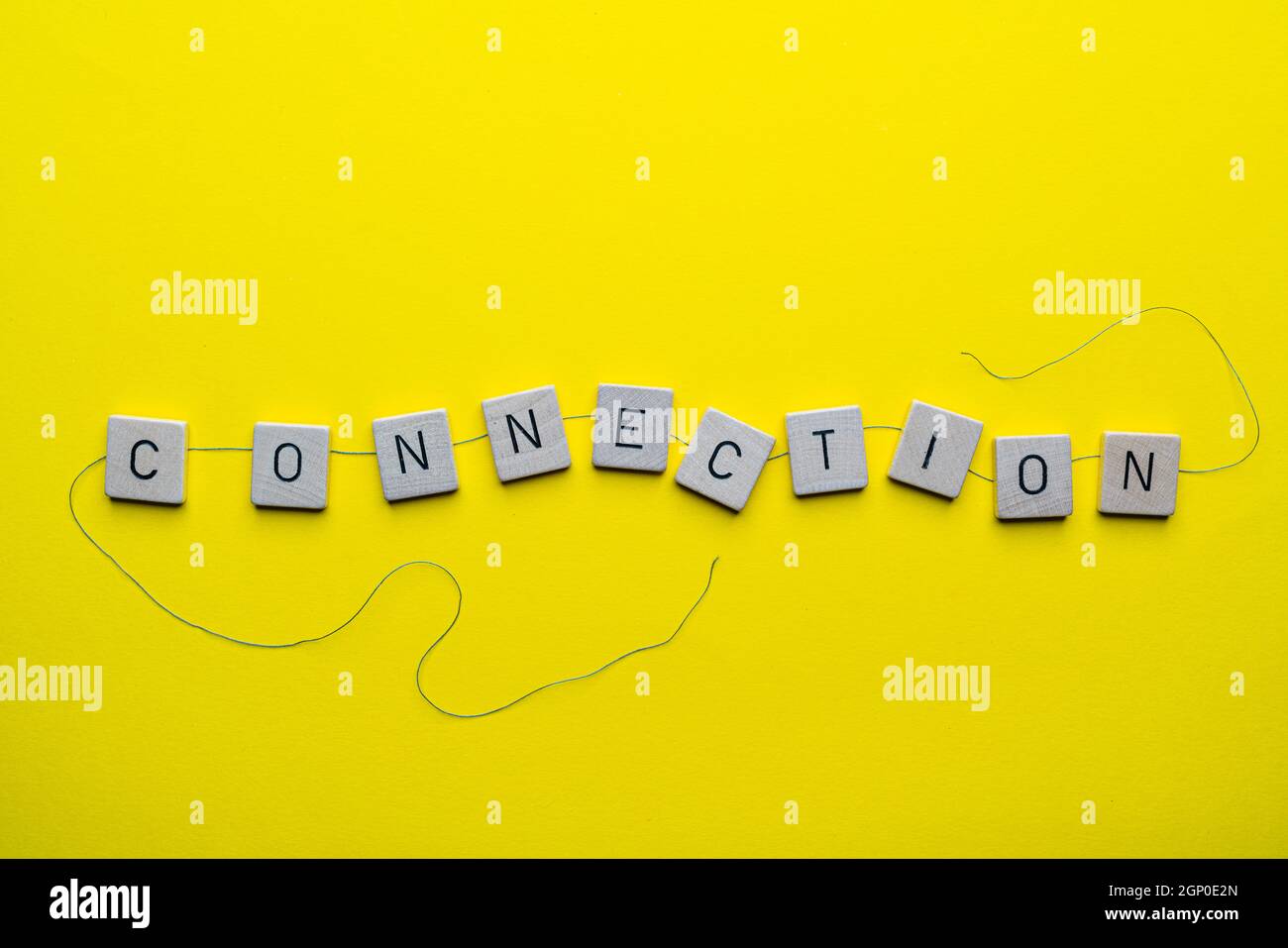 the word connection formed with the letters linked together by a thread ...
