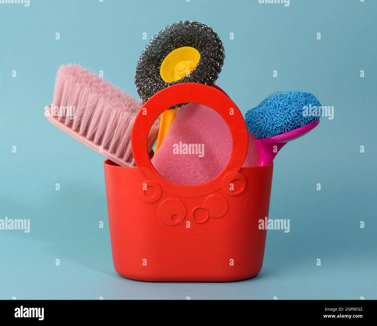 red basket with washing sponges, brushes on a blue background, set ...