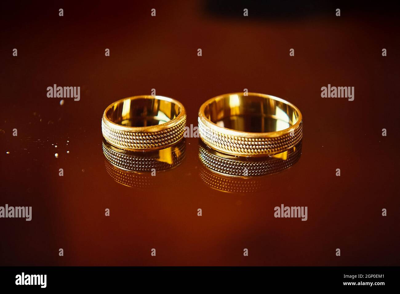 Two wedding rings on a red background. Wedding rings Stock Photo - Alamy