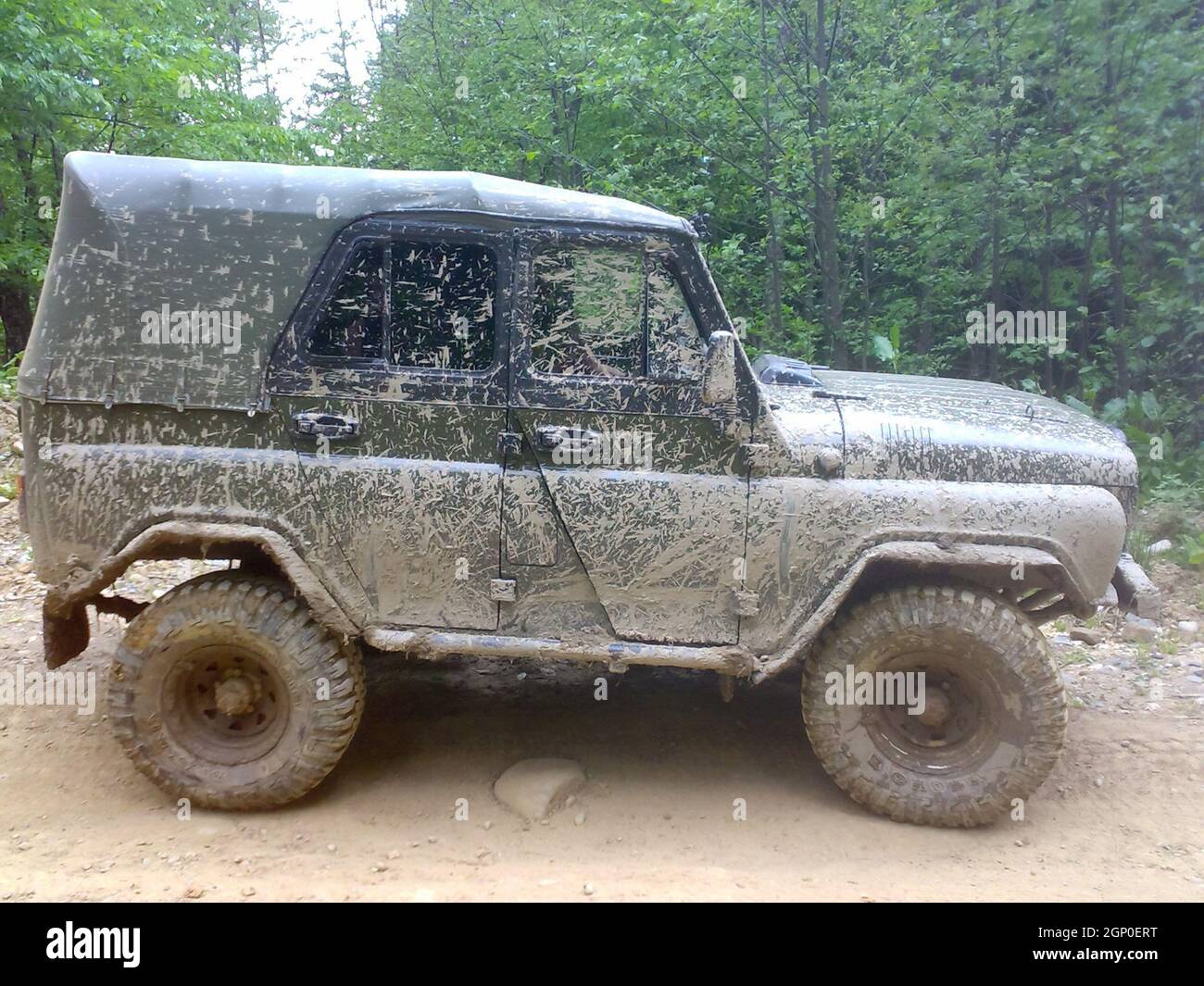 It's a very dirty car. The SUV is driving through the mud Stock Photo ...