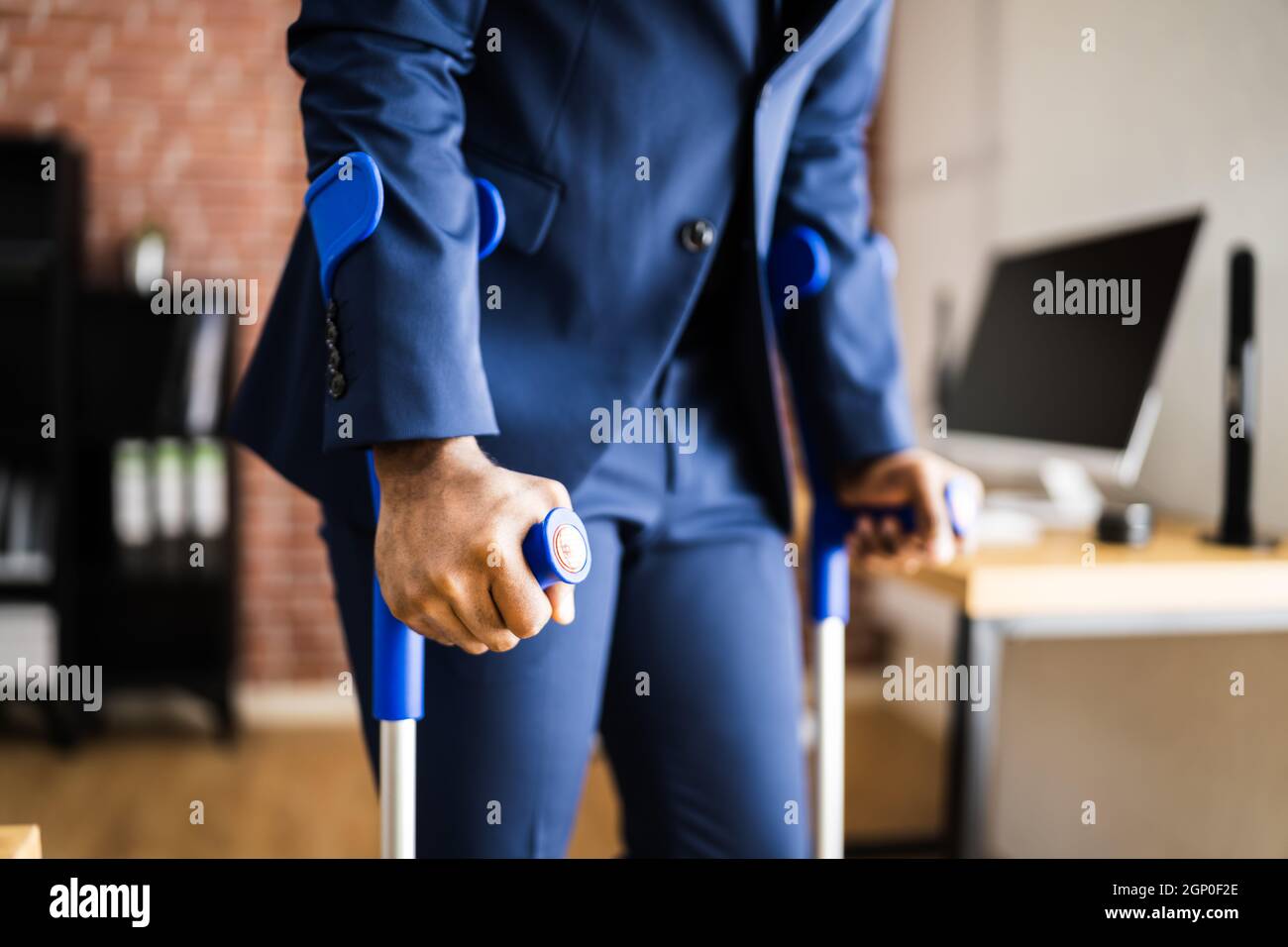 African Man Using Crutches For Recovery After Leg Fracture Stock Photo ...