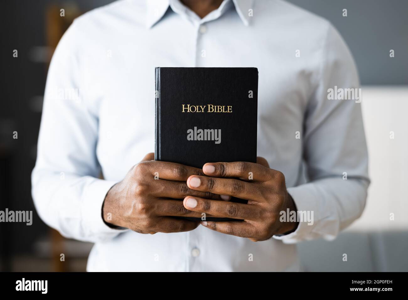 African American Black Christian. Bible In Prayer Hands Stock Photo - Alamy