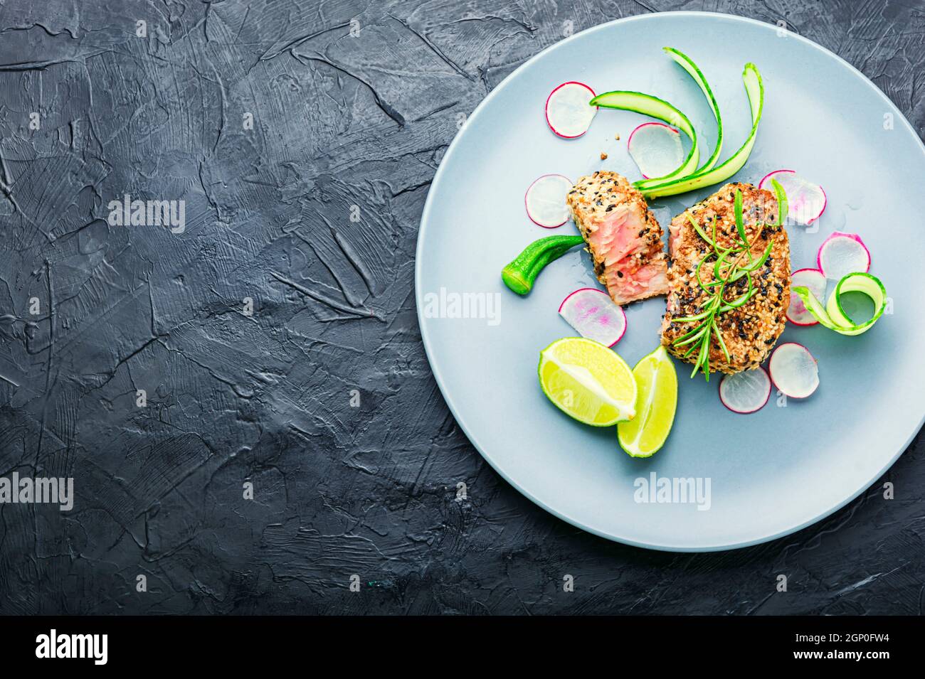 Baked tuna steak with vegetable garnish.Fish cooked with vegetables ...