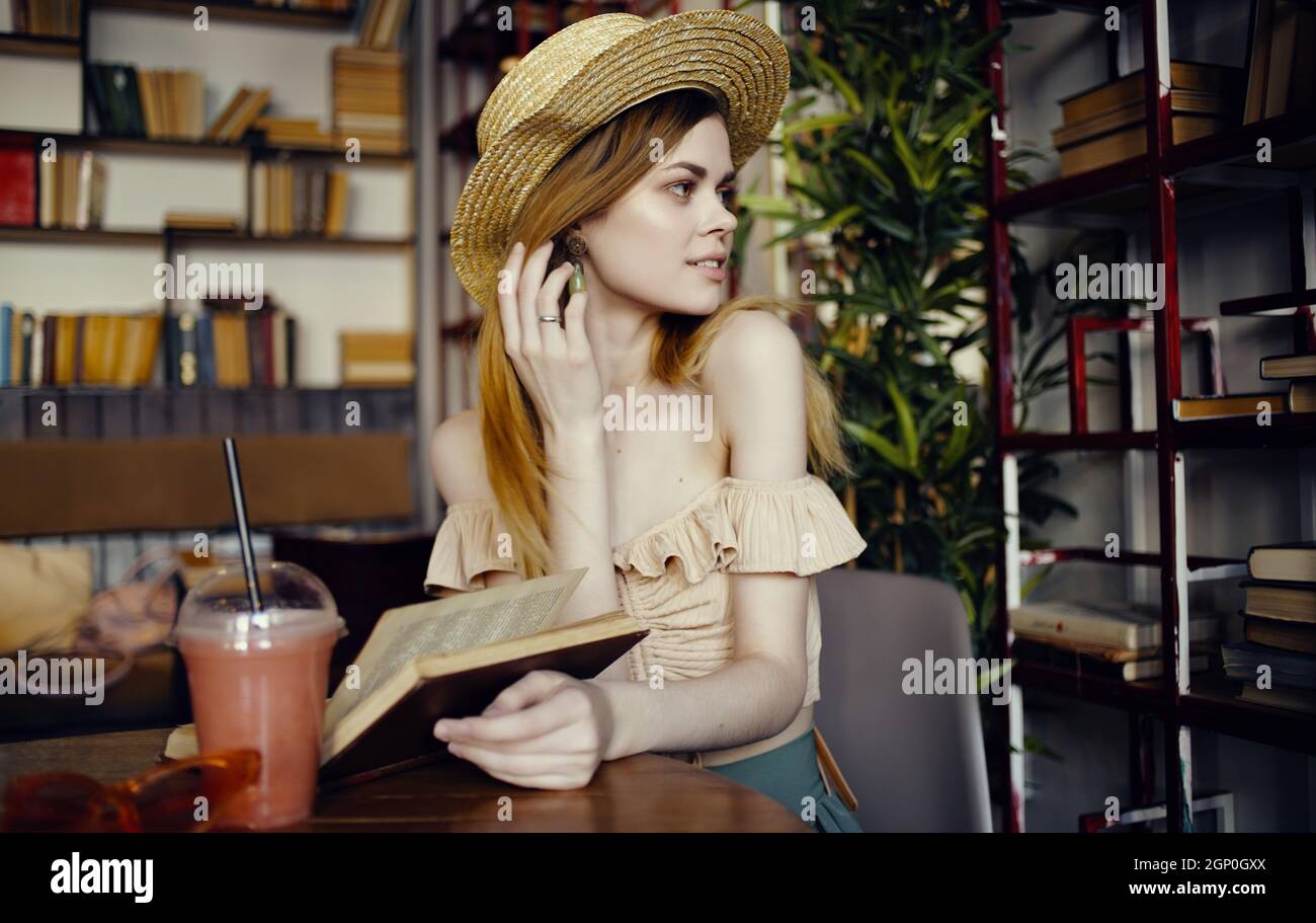 pretty woman sitting at the table library rest reading Stock Photo - Alamy