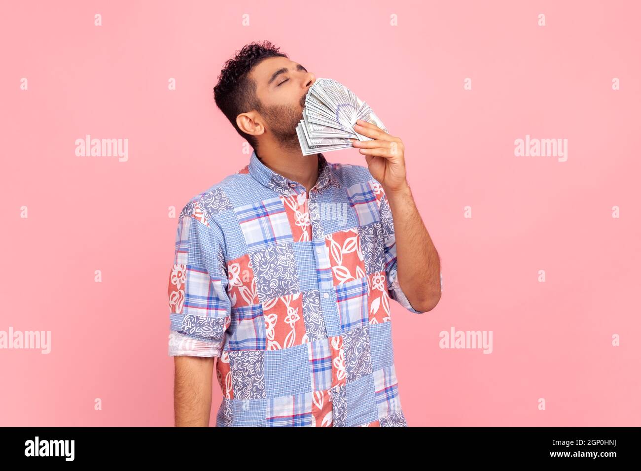 Portrait of handsome greedy arrogant man with beard smelling dollar ...