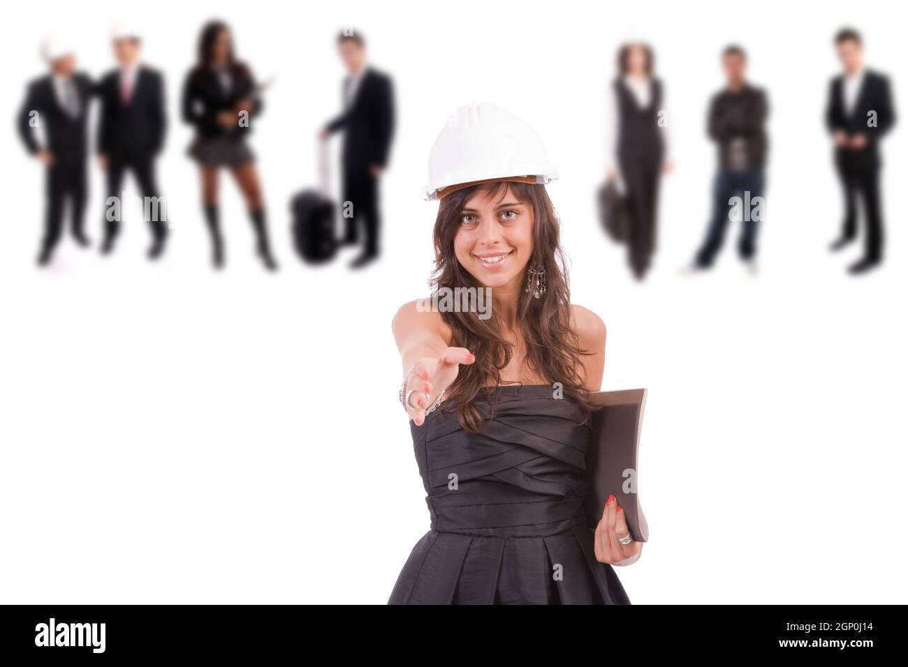 Young engineer posing with some people in the back Stock Photo - Alamy