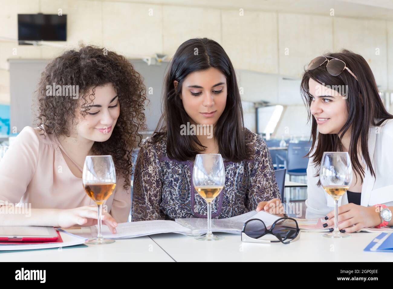 Group of happy students preparing their exams or simply relaxing at a ...