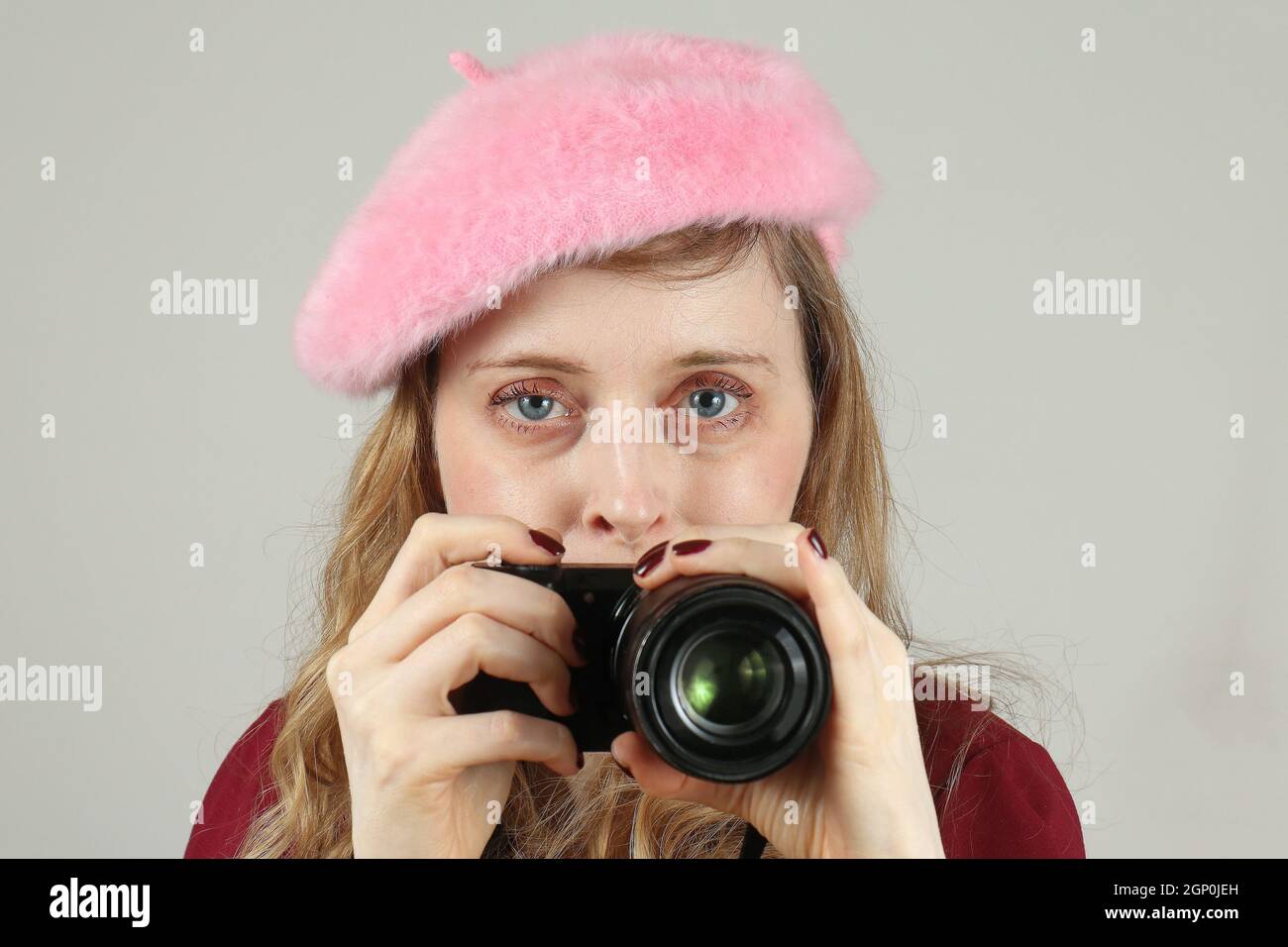 Young teenage girl holding small modern digital camera taking pictures ...