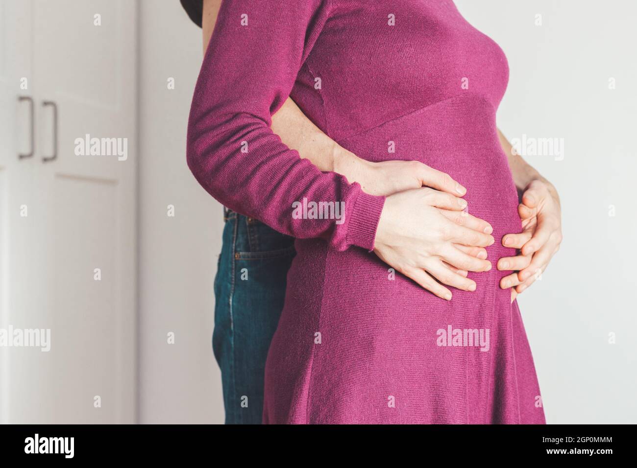 Close up of pregnant mother and father, hugging the tummy, Caucasian ...