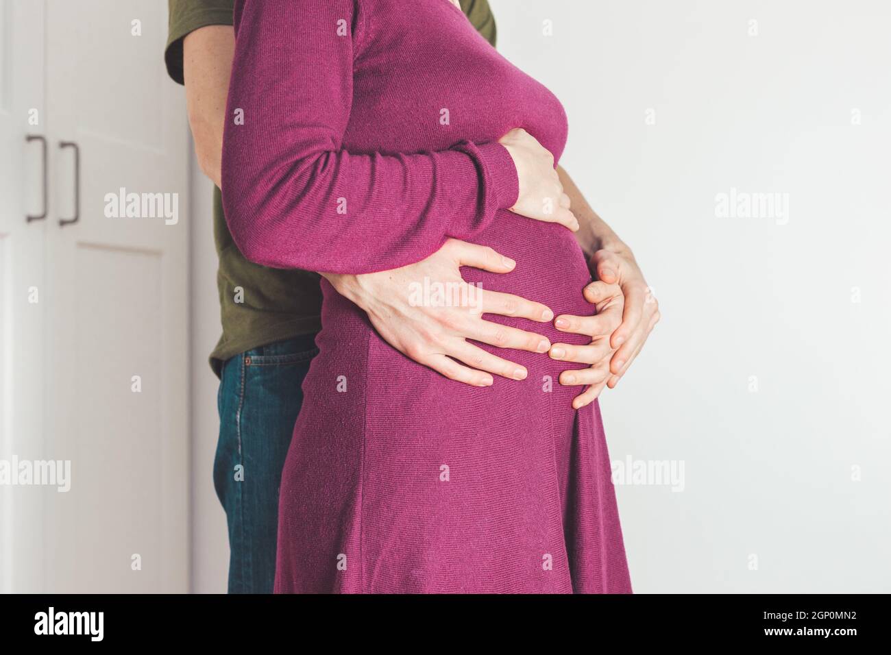 Close up of pregnant mother and father, hugging the tummy, Caucasian ...