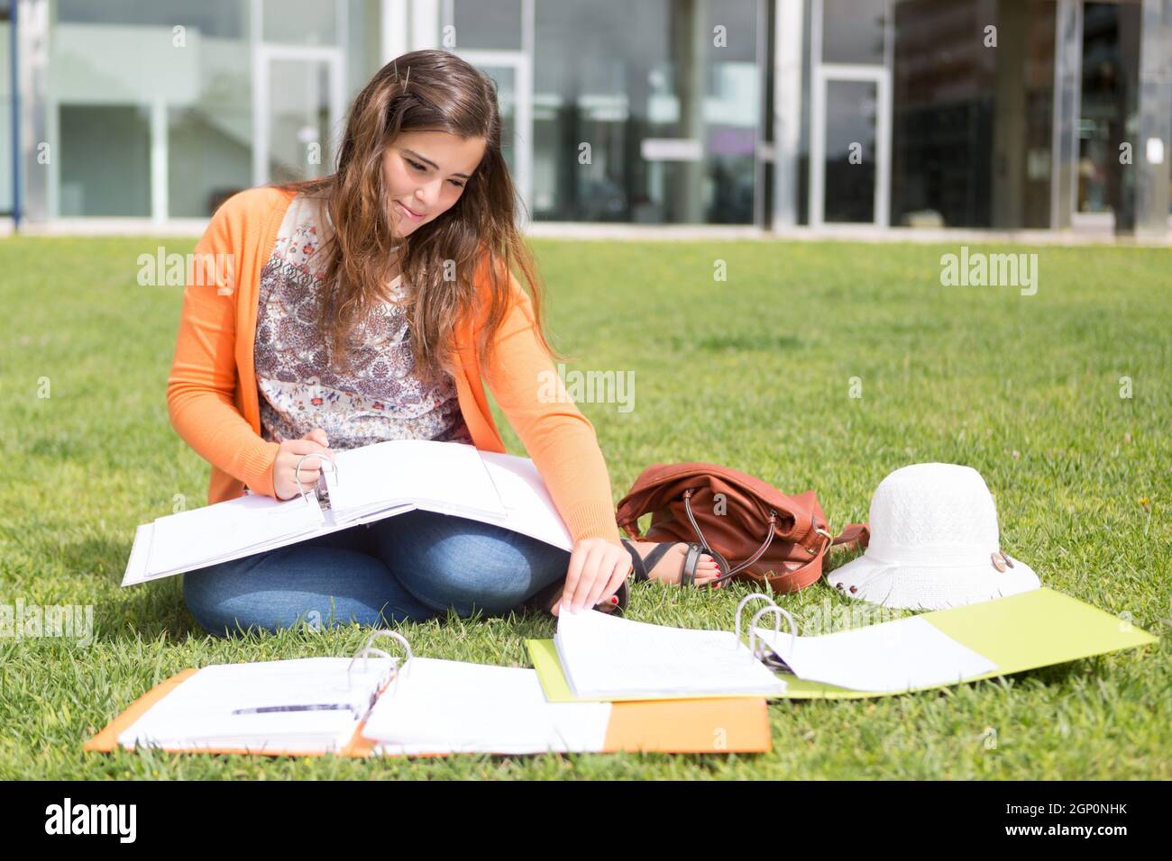 Young woman studying at the university campus Stock Photo - Alamy