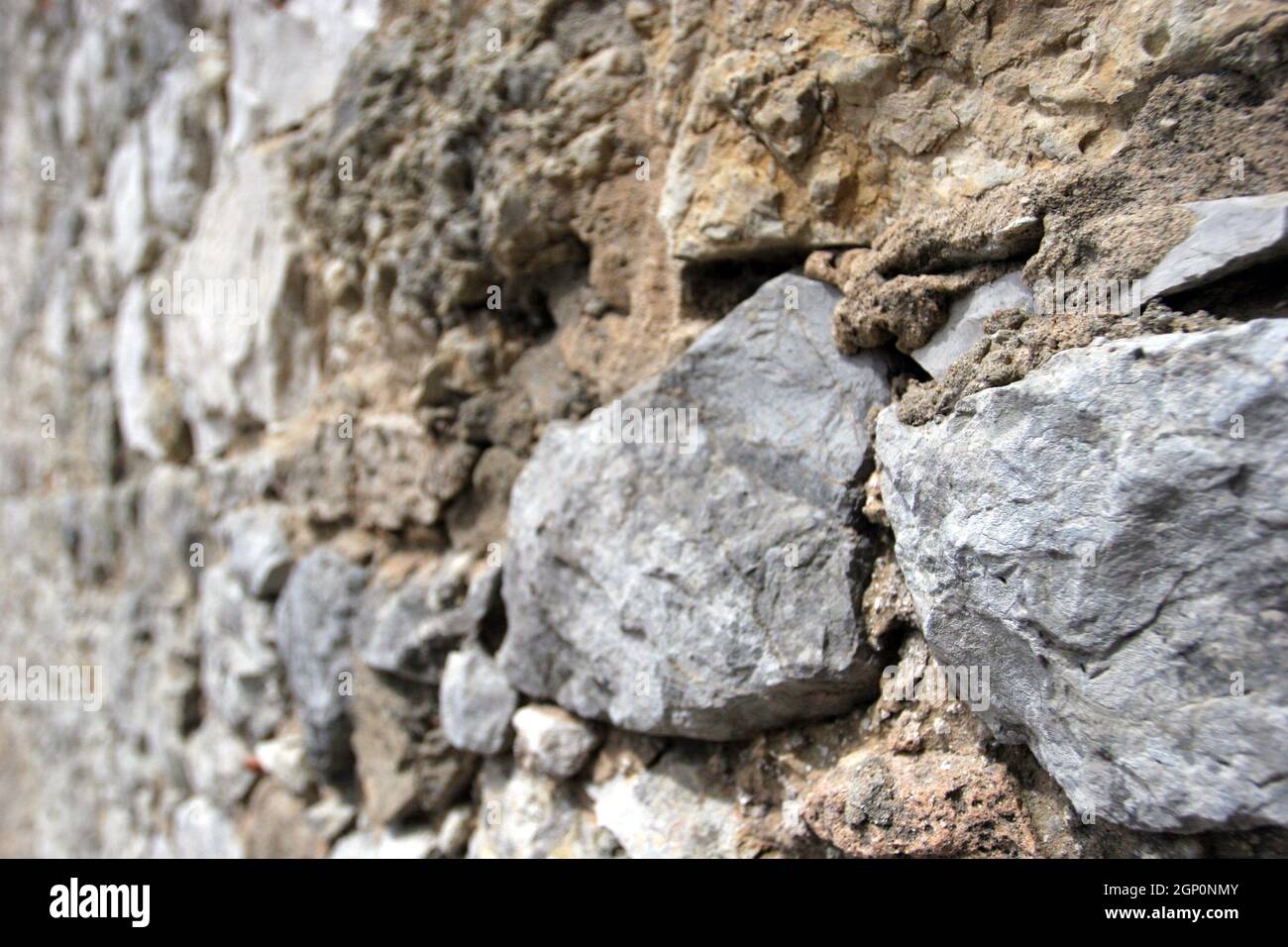 Old castle wall in perspective, focus on the first plan Stock Photo - Alamy