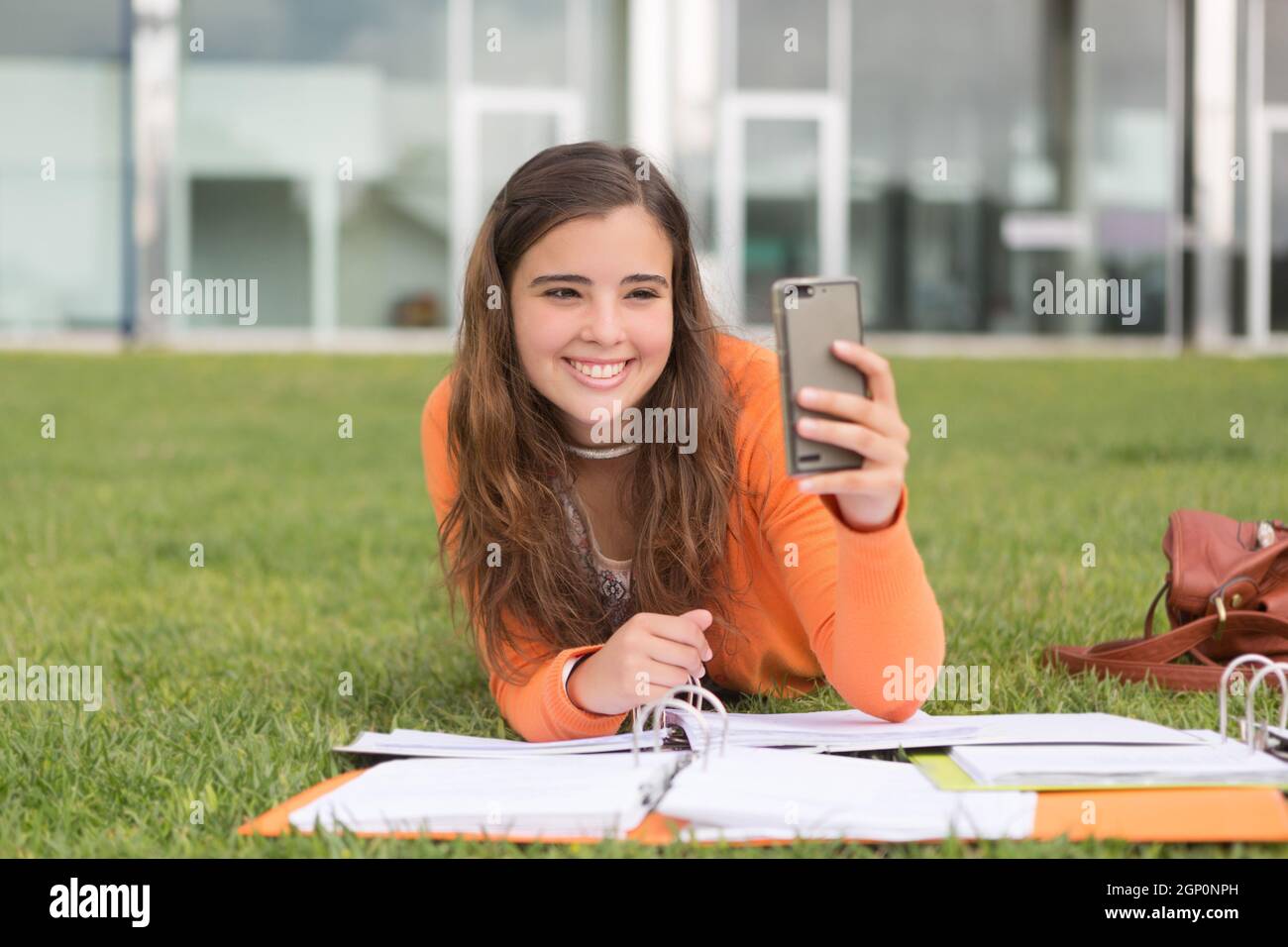 Young woman studying at the university campus Stock Photo - Alamy