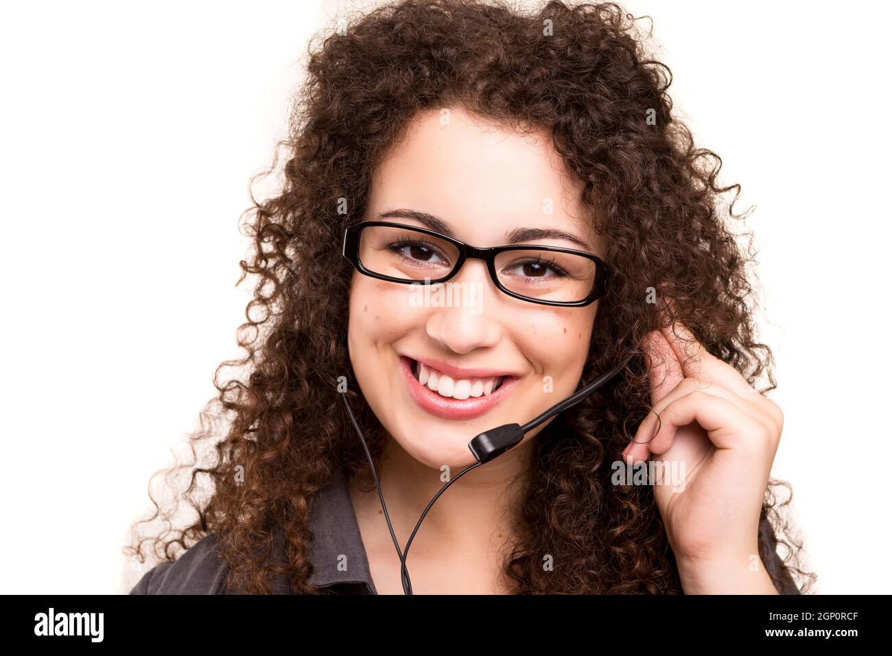 A friendly asian telephone operator smiling isolated over a white ...