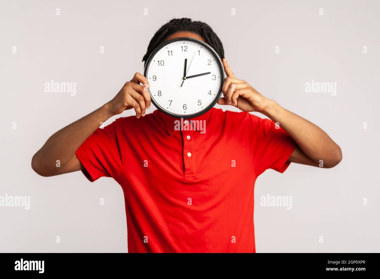 Unknown man with dreadlocks wearing red casual style T-shirt, hiding ...