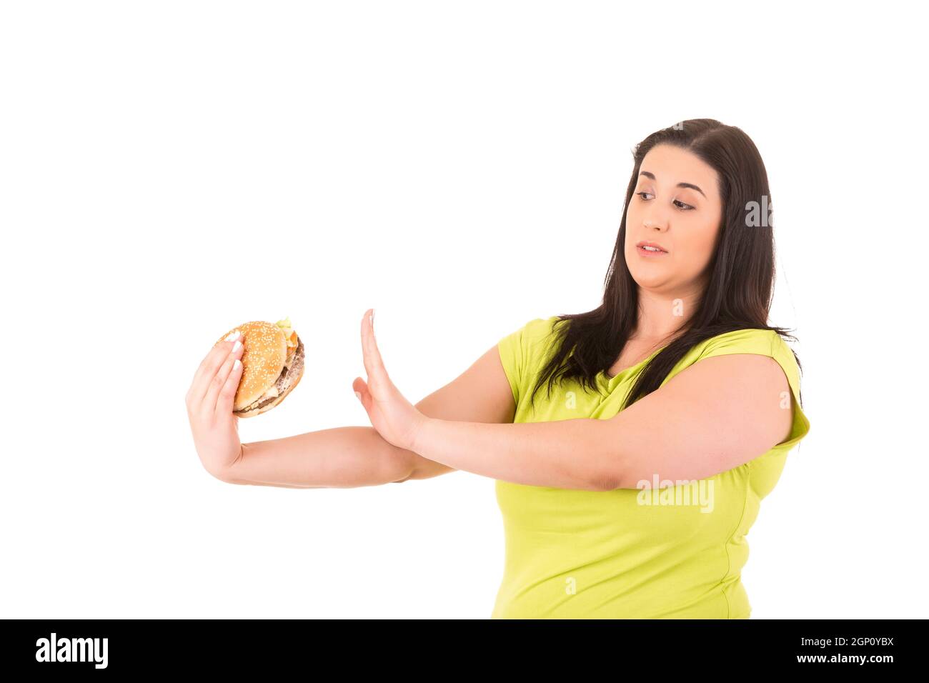 Beautiful large woman, trying to resist to an appetizing hamburger ...