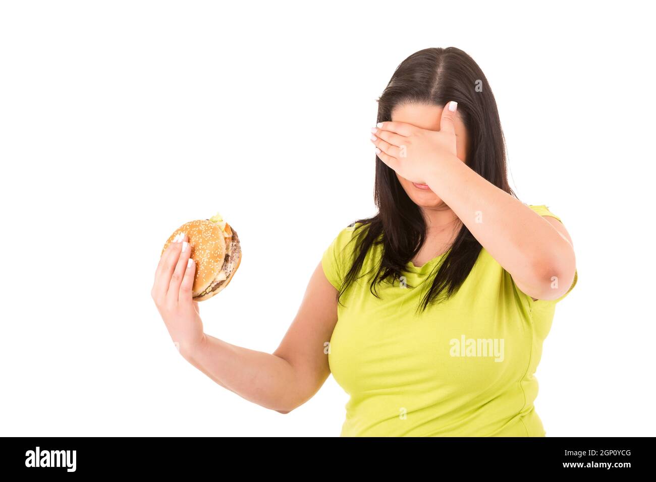 Beautiful large woman, trying to resist to an appetizing hamburger ...