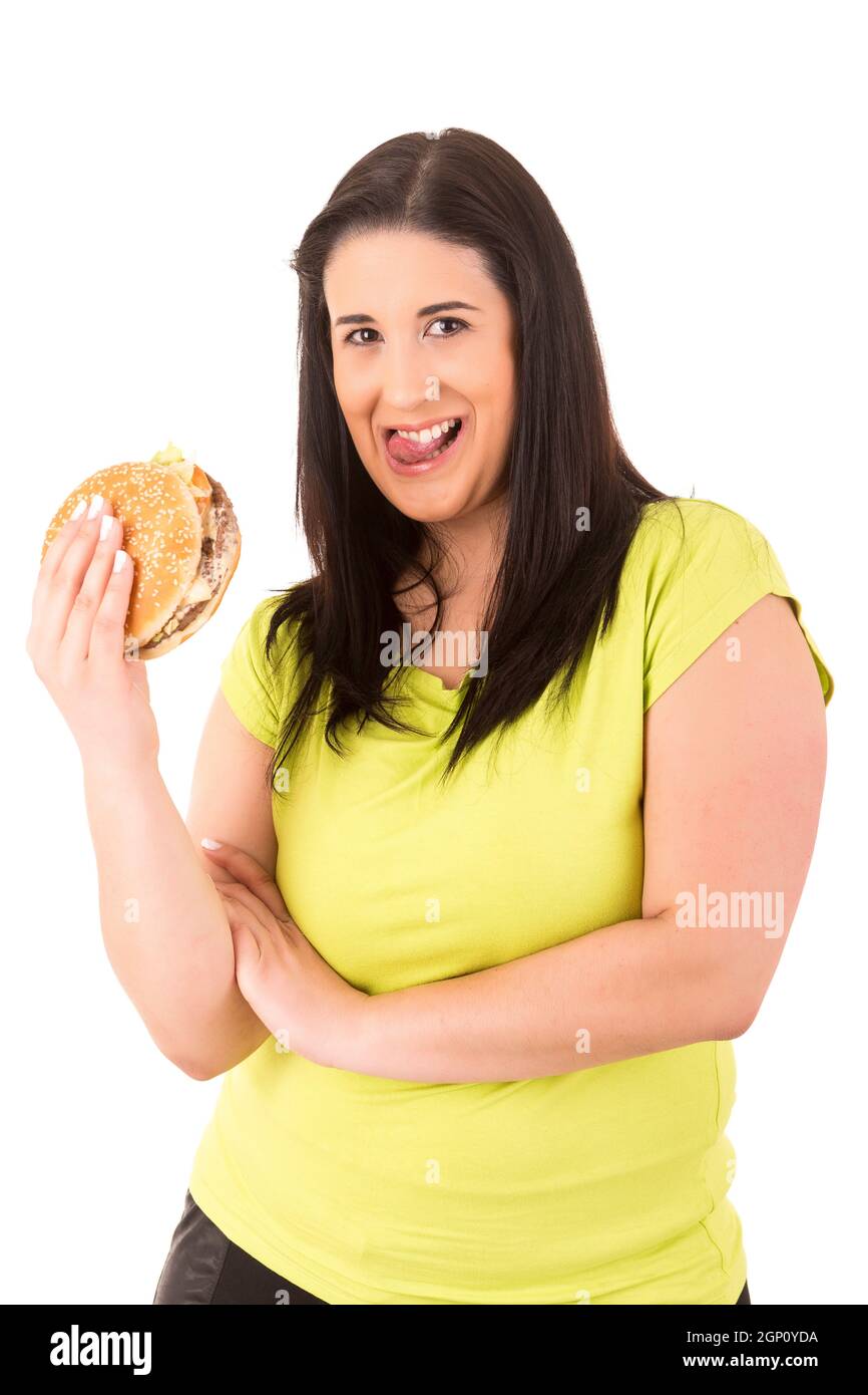 Beautiful large woman, trying to resist to an appetizing hamburger ...