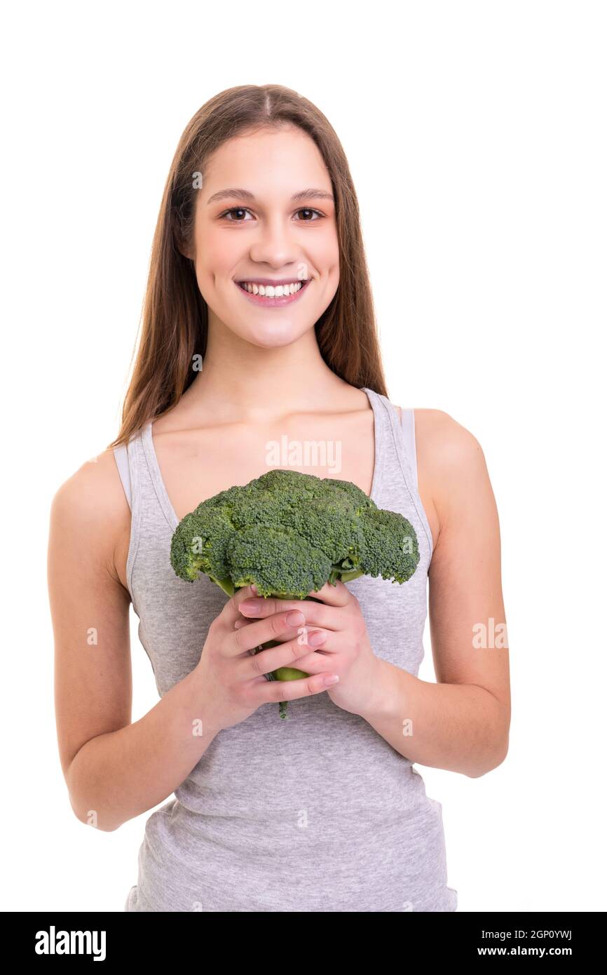 How to cook broccoli? Beautiful young woman holding broccoli and while ...