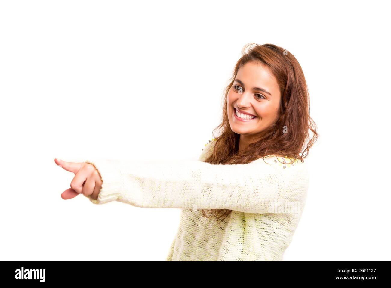 A beautiful woman pointing to something, isolated over a white ...