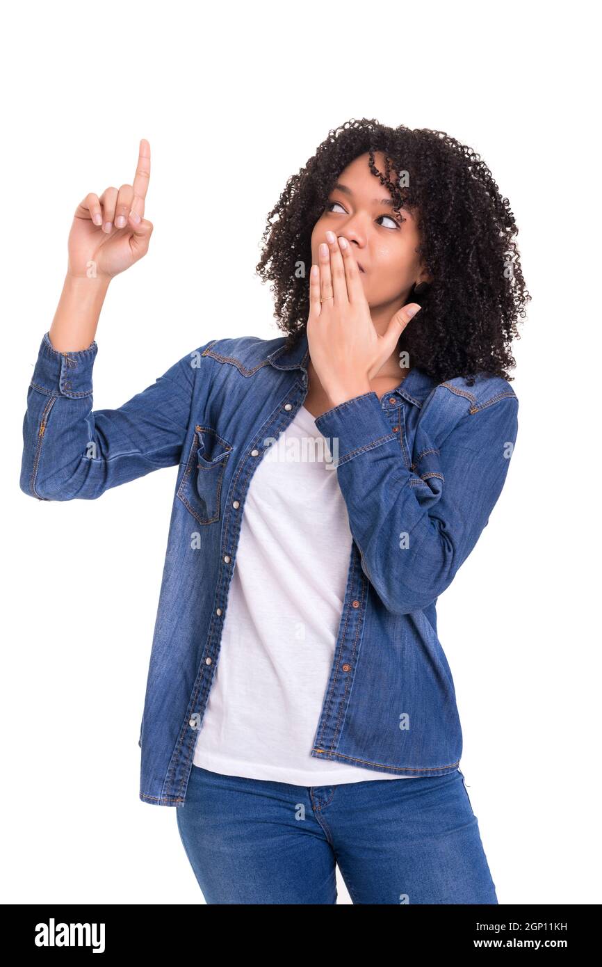 A beautiful african woman pointing to something, isolated over a white ...