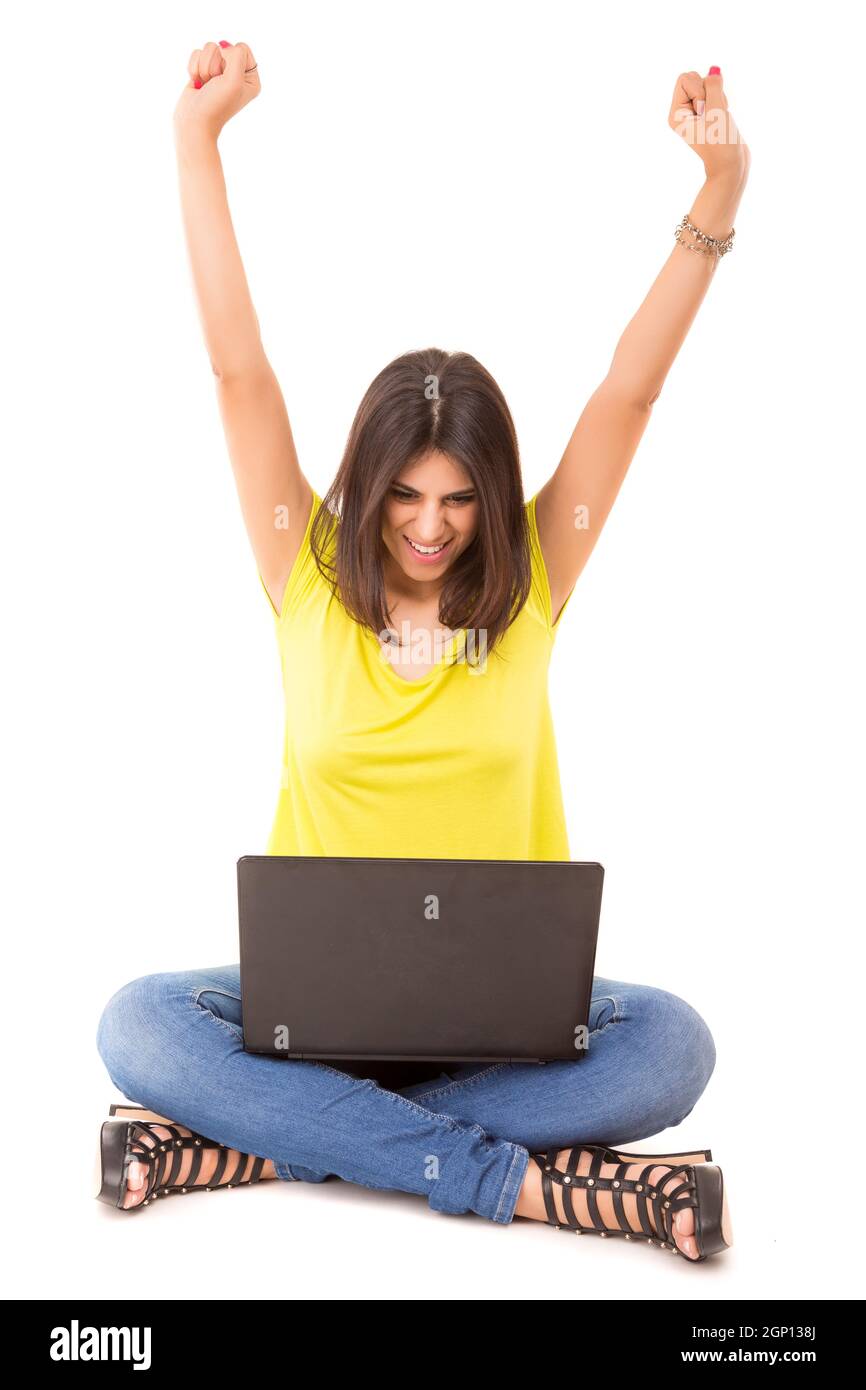 Young student working with her laptop, isolated over a white background ...