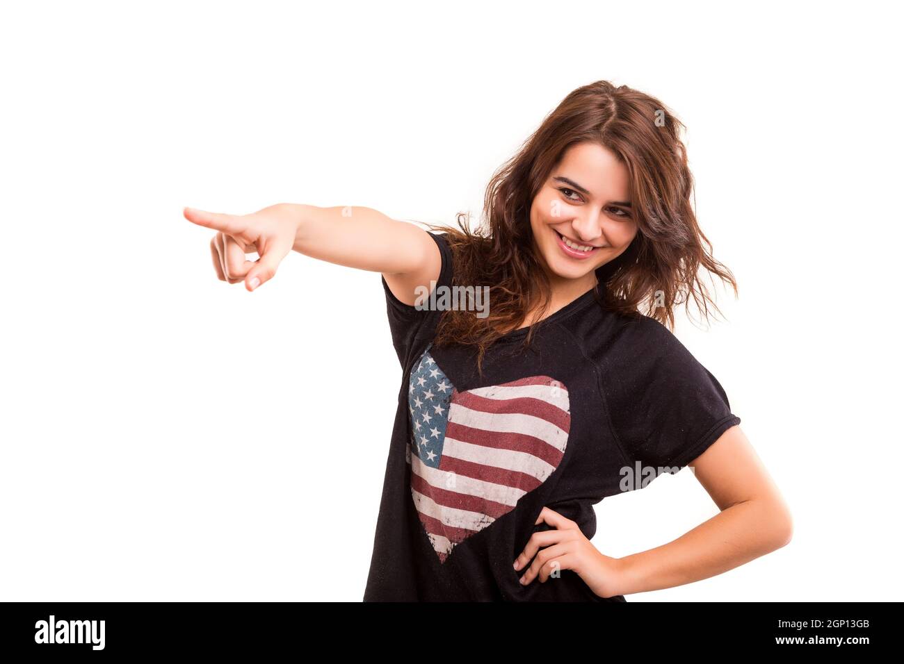 A beautiful woman pointing to something, isolated over a white ...