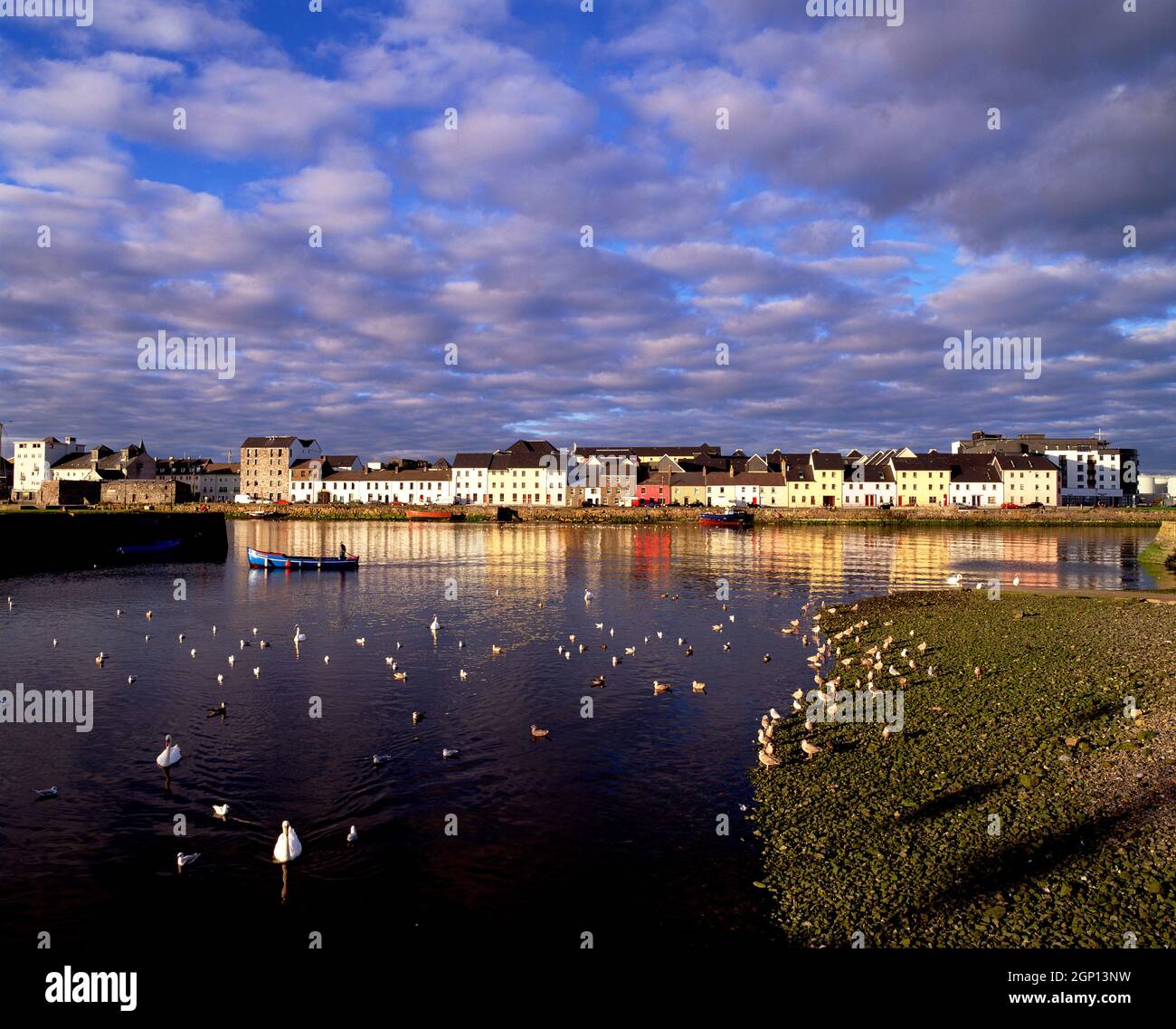Small boat sailing past the Claddagh, Galway City, Ireland Stock Photo ...