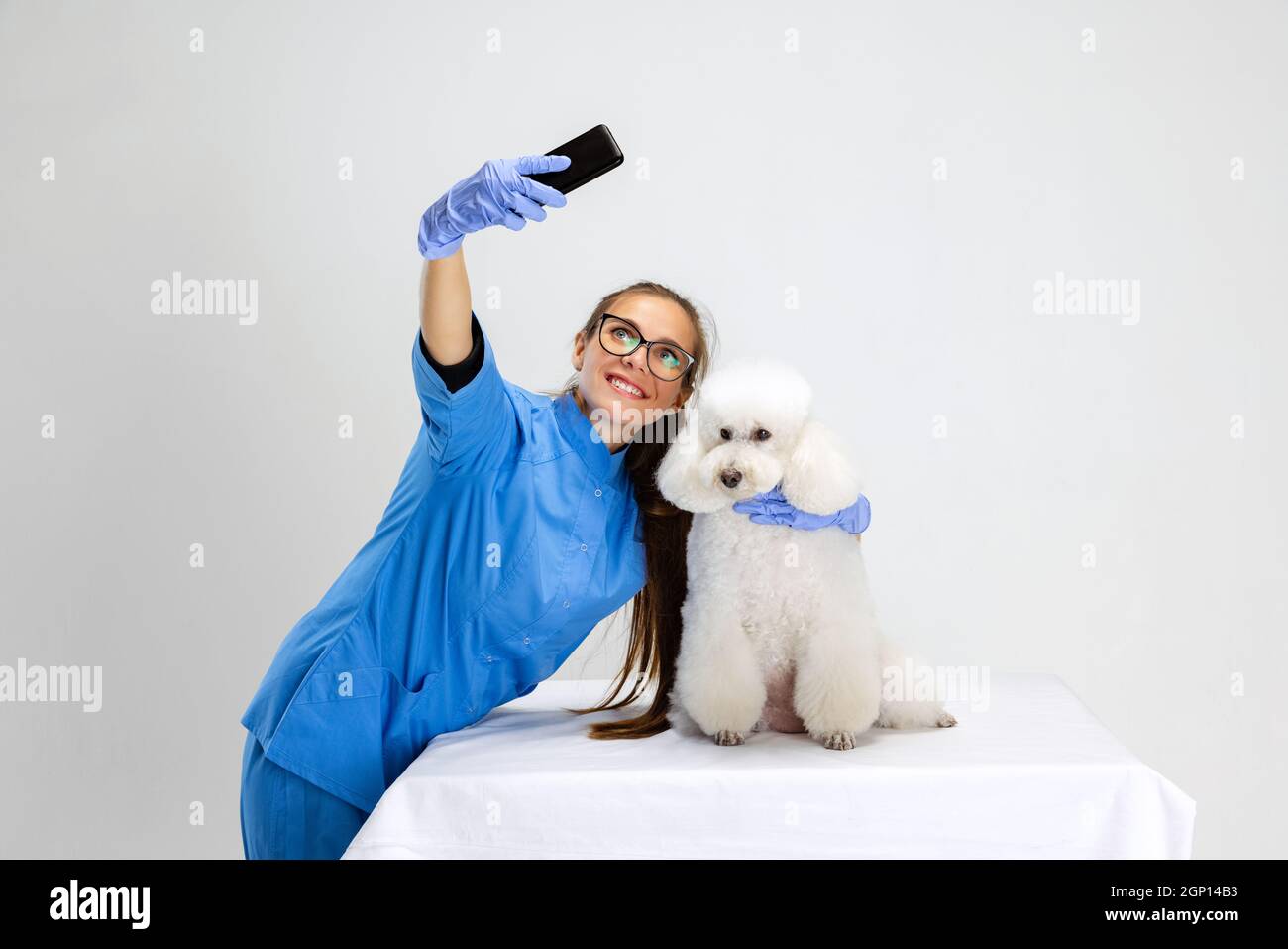 Portrait of young beautiful woman, female veterinary, vet doctor and ...