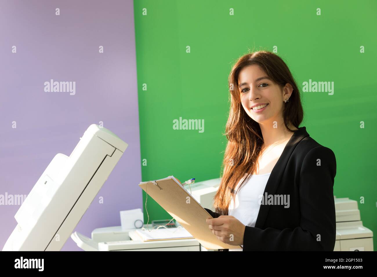 A young student at a copy center taking some copies for her final exams ...