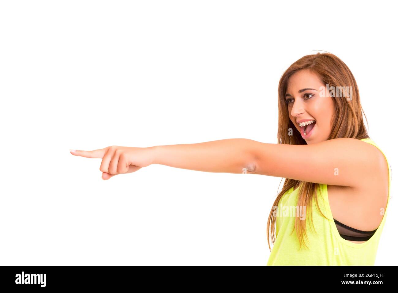 A beautiful teenager pointing to something, isolated over a white ...