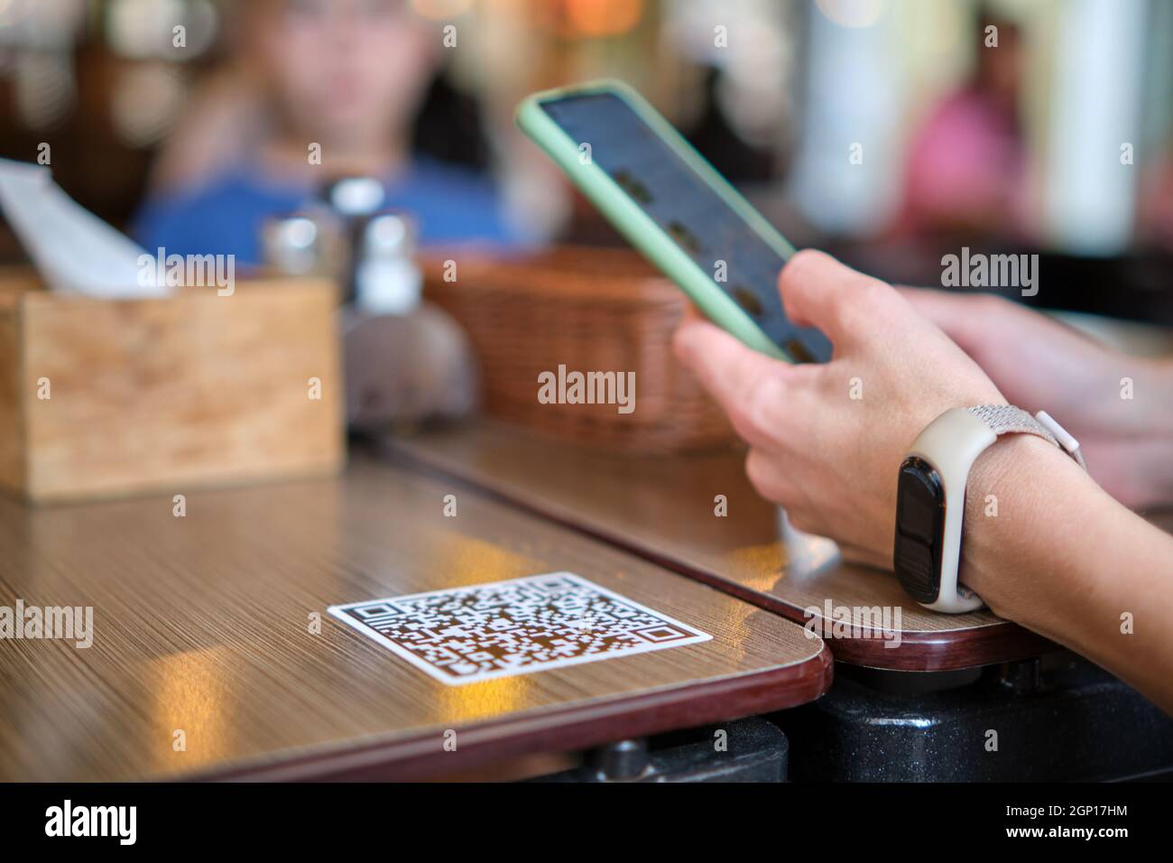 Closeup of guest hand ordering meal in restaurant while scanning qr ...